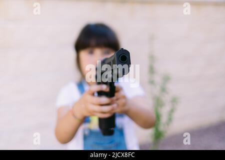 Little girl pointing a gun. Concept of violence, weapons, guns ...