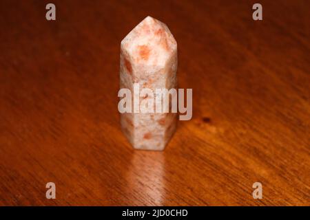 Polished sunstone also known as Andesine isolated on white background ...