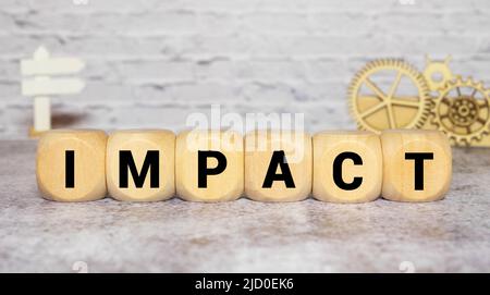 impact word written on wood block. impact text on table, concept Stock ...