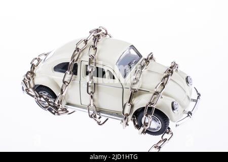 Chained white car on white background Stock Photo - Alamy