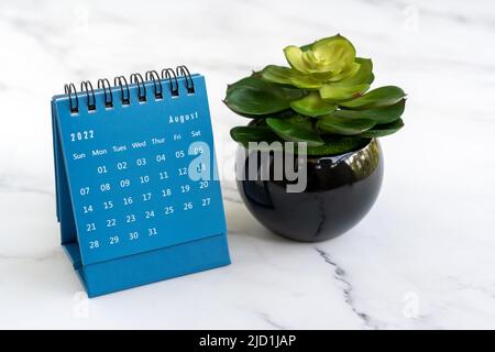 The August 2022 desk calendar with plant on wooden table Stock Photo ...