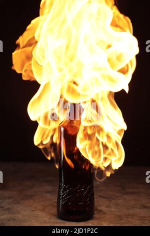 Beer bottle in fire and flame Stock Photo - Alamy