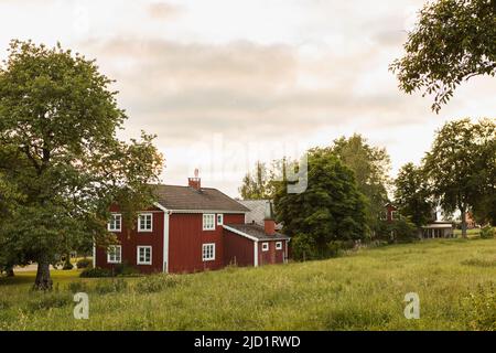 Falun red farm in rural landscape Stock Photo - Alamy