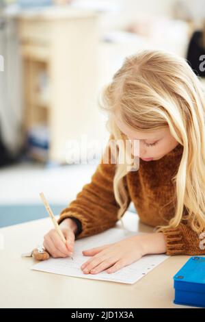 Girl doing writing assignment at school Stock Photo - Alamy