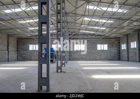 Ceiling of large factory building with artificial lighting. Industrial ...