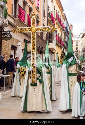 Cofrades in their traditional costumes with capirote, parading through ...