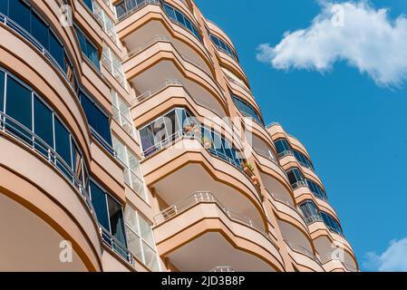 Diagonal view of a modern residential building facade with colorful ...