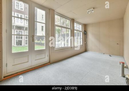 Interior of spacious empty room with tiled floor with white wooden ...