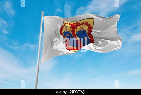 official flag of Viborg , Denmark at cloudy sky background on sunset ...
