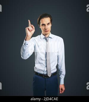 Warning concept wih young handsome man in white shirt with raising hand ...