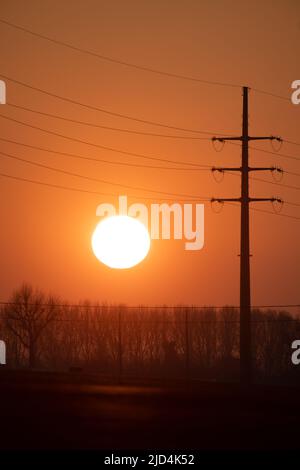 Harnassing the power of sun. Telephoto of a setting sun, contrasted ...