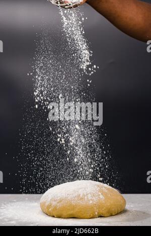 Hands splashing wheat flour kneaded Stock Photo - Alamy