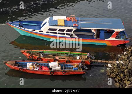 Typical ferry boats in Manado port with the Soekarno Bridge beyond in ...