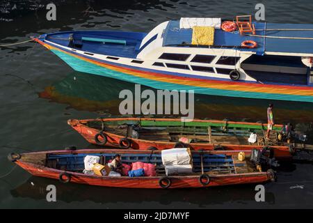 Typical ferry boats in Manado port with the Soekarno Bridge beyond in ...