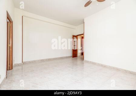 Empty room with ceramic tile floors, golden aluminum window with ...