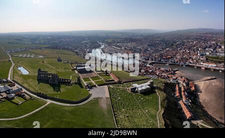 Elevated panorama of Whitby harbour town abbey and church headland ...