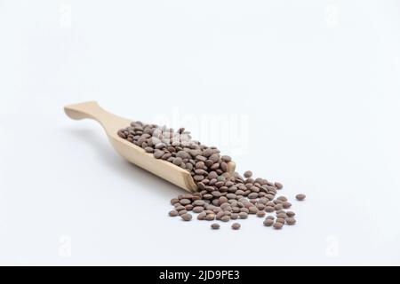 wooden pallet containing raw lentils on a white surface Stock Photo - Alamy