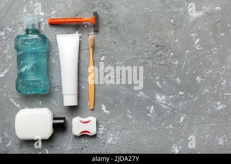 Toothpaste and bath accessories on grey table Stock Photo - Alamy