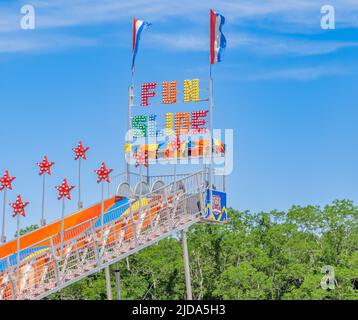 Fun Slide carnival ride, detail of top, colorful flags and lights Stock ...