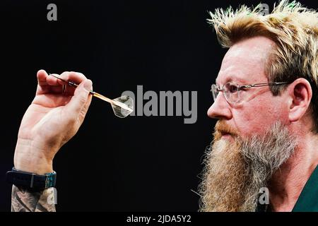 Simon Whitlock of Australia throws a dart as he takes part in a round ...