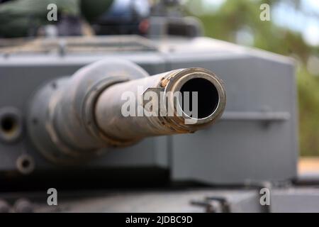 Tank gun, barrel muzzle of a military army close-up. Broken burnt tank ...
