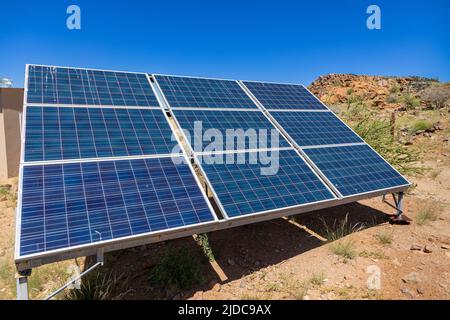 Solar power station in arid area under clear blue sky. Solar power ...