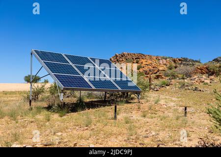 Solar power station in arid area under clear blue sky. Solar power ...