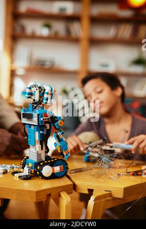 Smart African boy making a robot at home for science class. Robotics ...