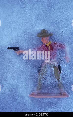 Model cowboy firing gun Stock Photo - Alamy