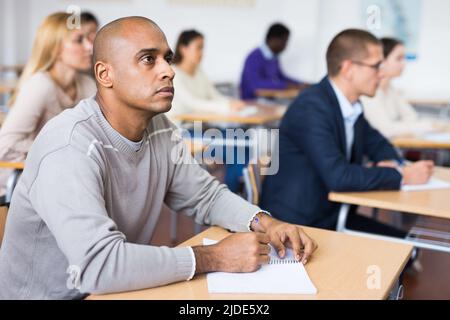 Hispanic man listening lecture during adult education class Stock Photo ...
