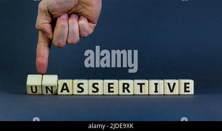 Assertive or unassertive symbol. Businessman turns wooden cubes and ...