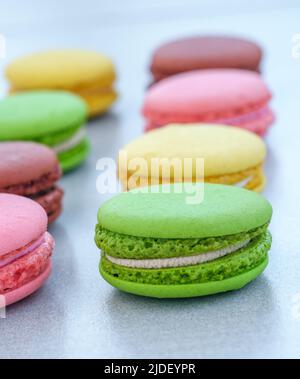 Stack of various flavors french macaroons served on white plate on ...