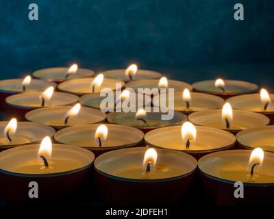 Lots of small lit candles. Dark mysterious atmosphere.Candle background ...