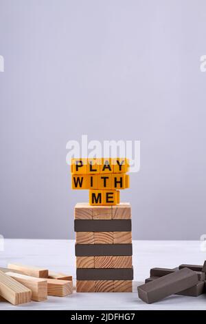A vertical shot of wooden block puzzle pieces on a white table Stock ...