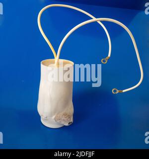 Swollen Electrolytic Capacitor (condenser or condensator) on red ...