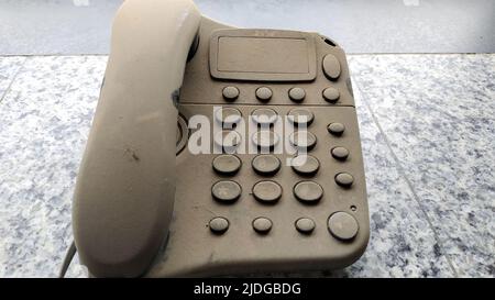 very old telephone with huge dust isolated on stone background Stock ...