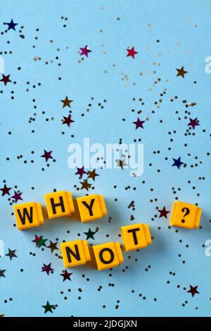 Vertical shot of yellow cubes with why not question inscription ...