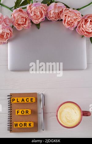 Cup of coffee, notebook, pen and rose flowers. Morning coffee break ...