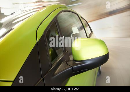 Detail of a car going around a corner in a built environment, creating ...