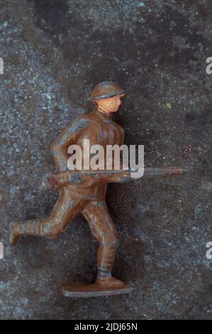 Worn lead model of World War 2 army foot soldier running with rifle at ...