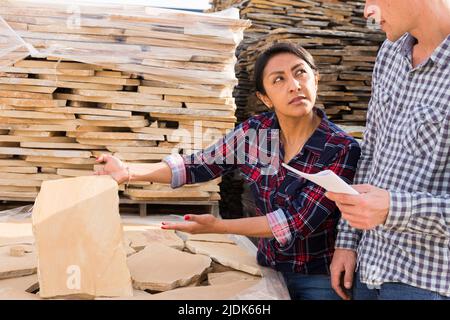Buyers choose natural stone tiles in the open area of hardware store ...