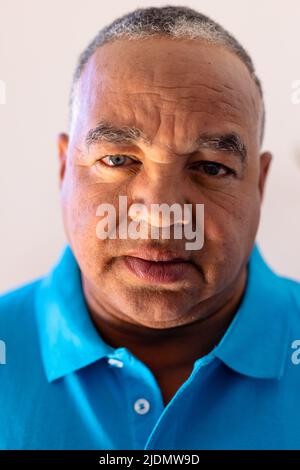 Eyes of happy biracial senior man with long beard, smiling in pottery ...