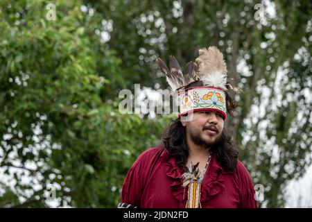 An Indigenous dancer watching the summer solstice ceremony. During this ...