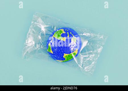 Planet earth model wrapped in plastic Stock Photo - Alamy