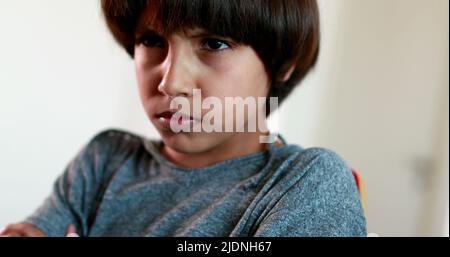 Angry child reaction crossing arms in anger. Offended young boy with ...