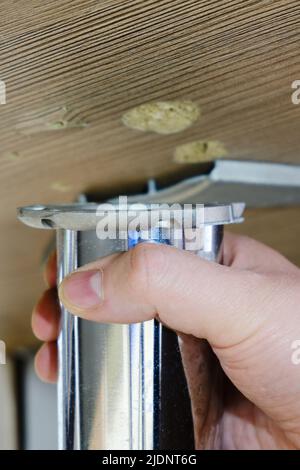 The repair contractor repairing broken furniture at home Stock Photo ...