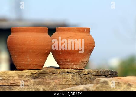 red color clay pot put on a stone Stock Photo - Alamy