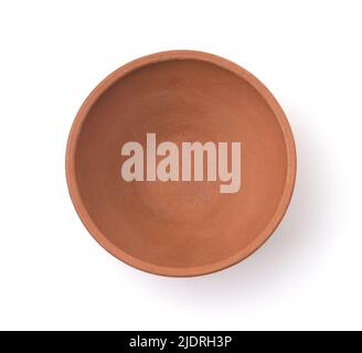 empty rustic terracotta kitchen bowl and spoon on a wooden tabletop ...