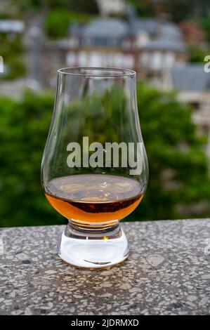 Dram of scotch whiskey with view on old houses on background, Edinburgh ...