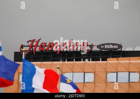 The sign 'Hampton', near the gallery of flags of the participating ...